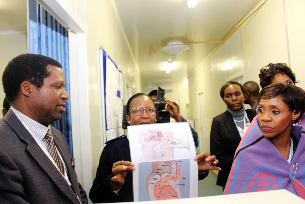 EGPAF SRH Director on the Left and EGPAF Nurse with pictures explain to ...